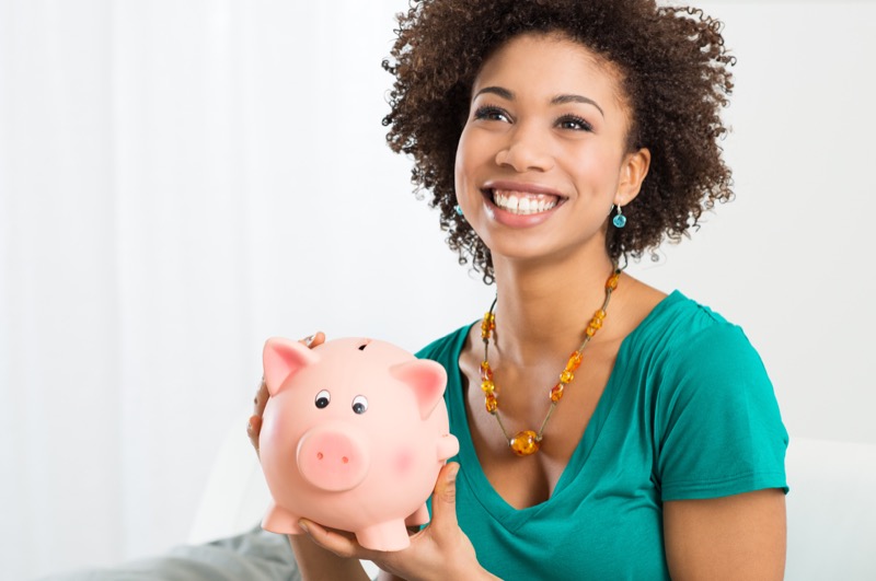 Happy Young Woman Saves Money in Piggy bank – Empowerteen